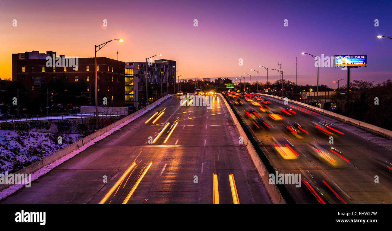 Traffic moving on the Jones Falls Expressway at twilight, in Baltimore ...