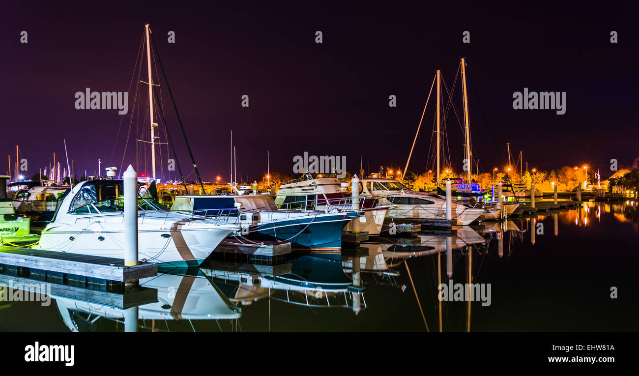 Boats reflecting in the water at night, in a marina on Kent Island ...