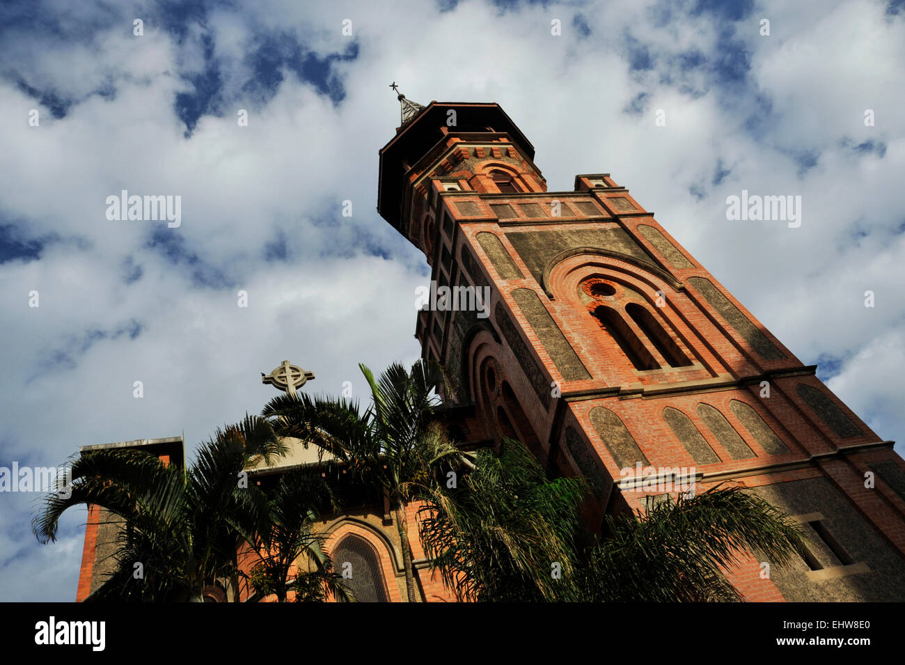 Silhouette of red brick bell tower of famous Roman Catholic Emmanuel Cathedral building against ...