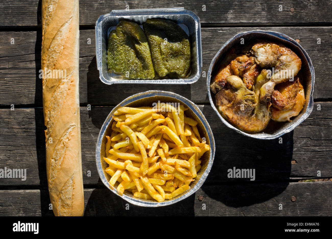 Spanish picnic set with bread, french fries, green peppers and chicken ...