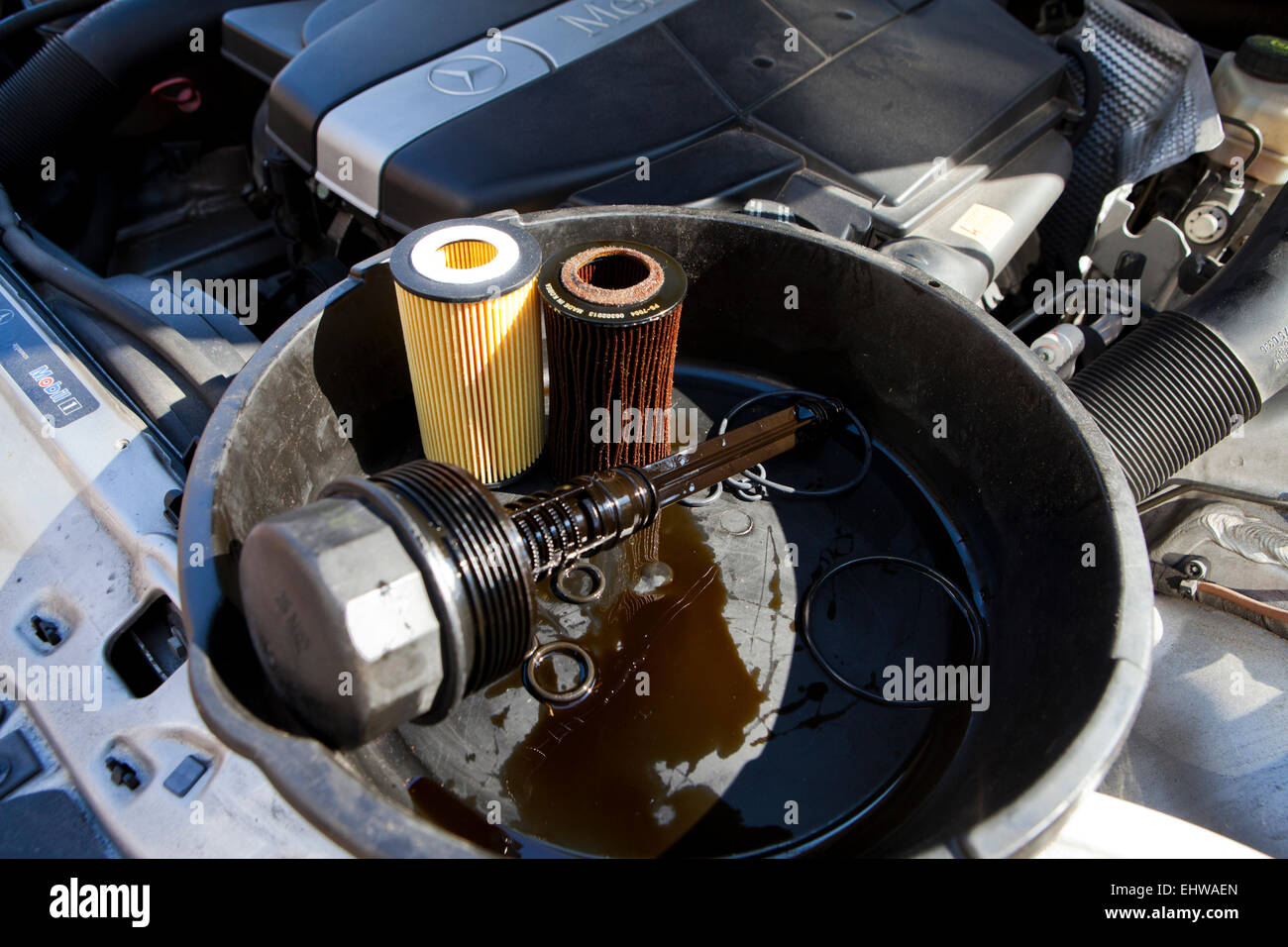 New and used motor oil filters in oil pan - USA Stock Photo - Alamy