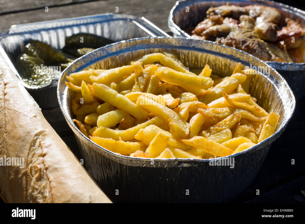 Spanish picnic set with bread, french fries, green peppers and chicken ...