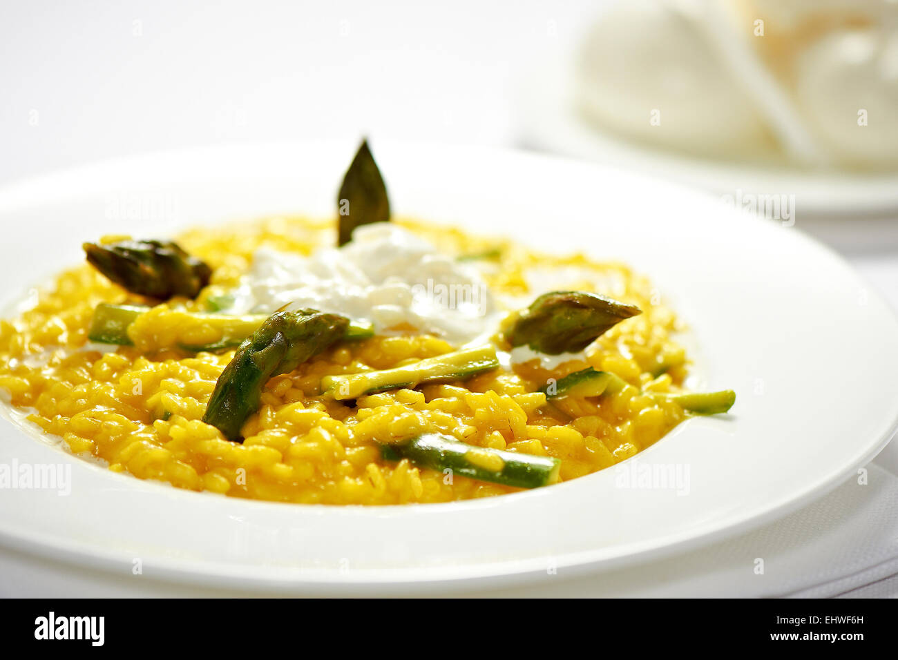 Serving of tasty traditional Italian risotto with asparagus tips and ...