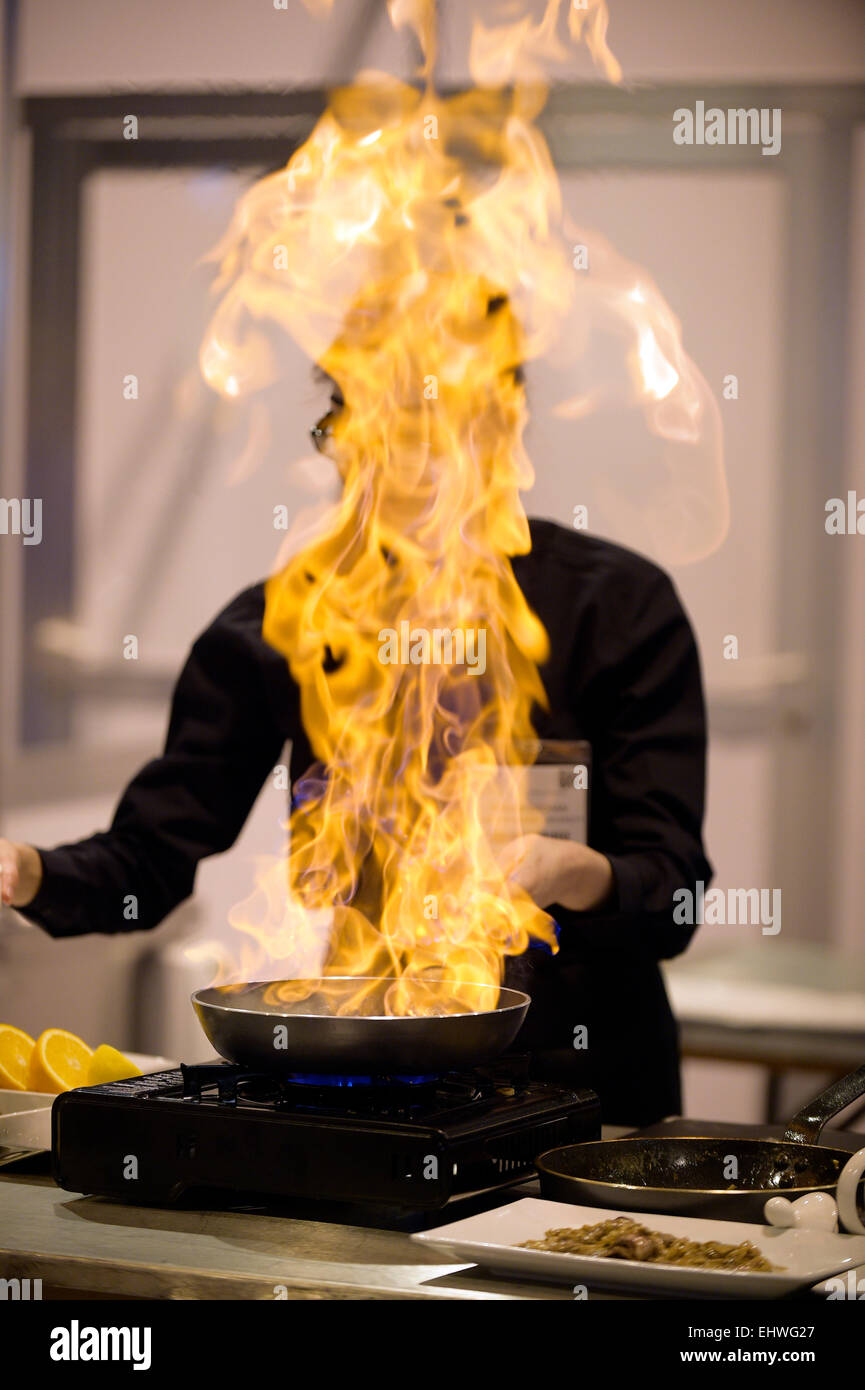 Female Chef cooking flambe dish at cooking competition, Scothot at the ...