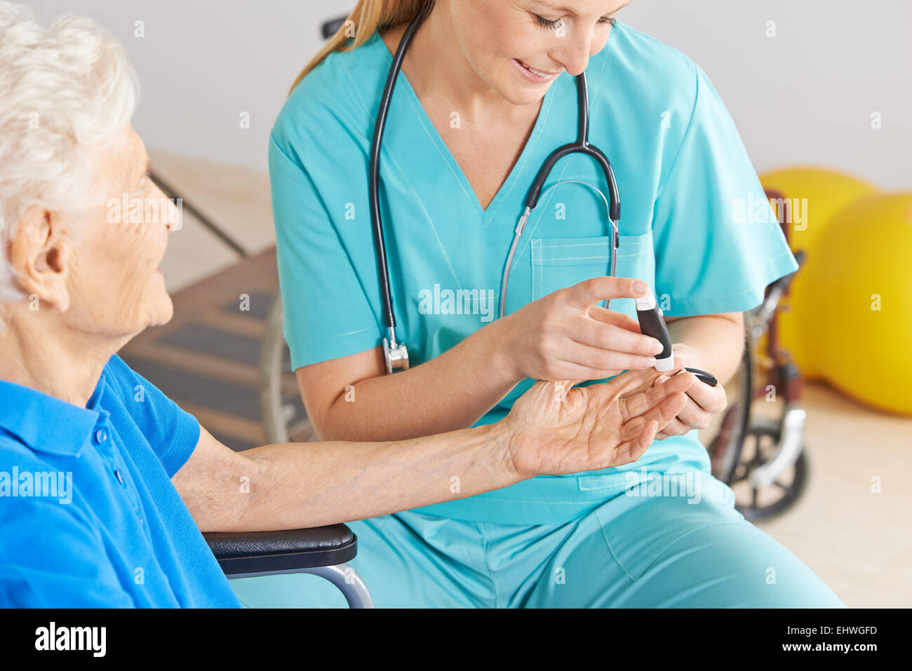 Geratric nurse monitoring blood sugar of senior woman with diabetes ...