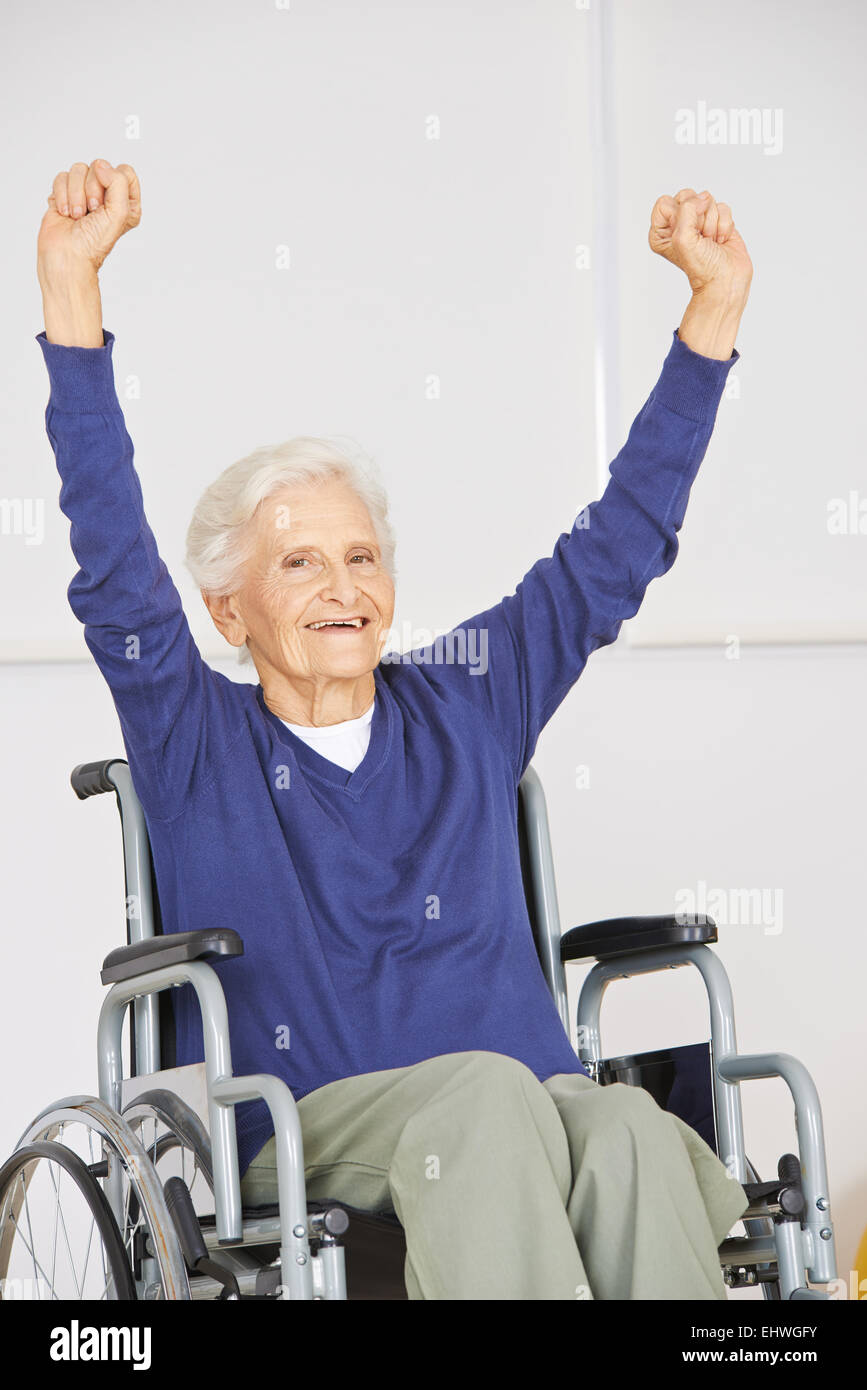 Old senior woman in wheelchair cheering with her arms up Stock Photo ...