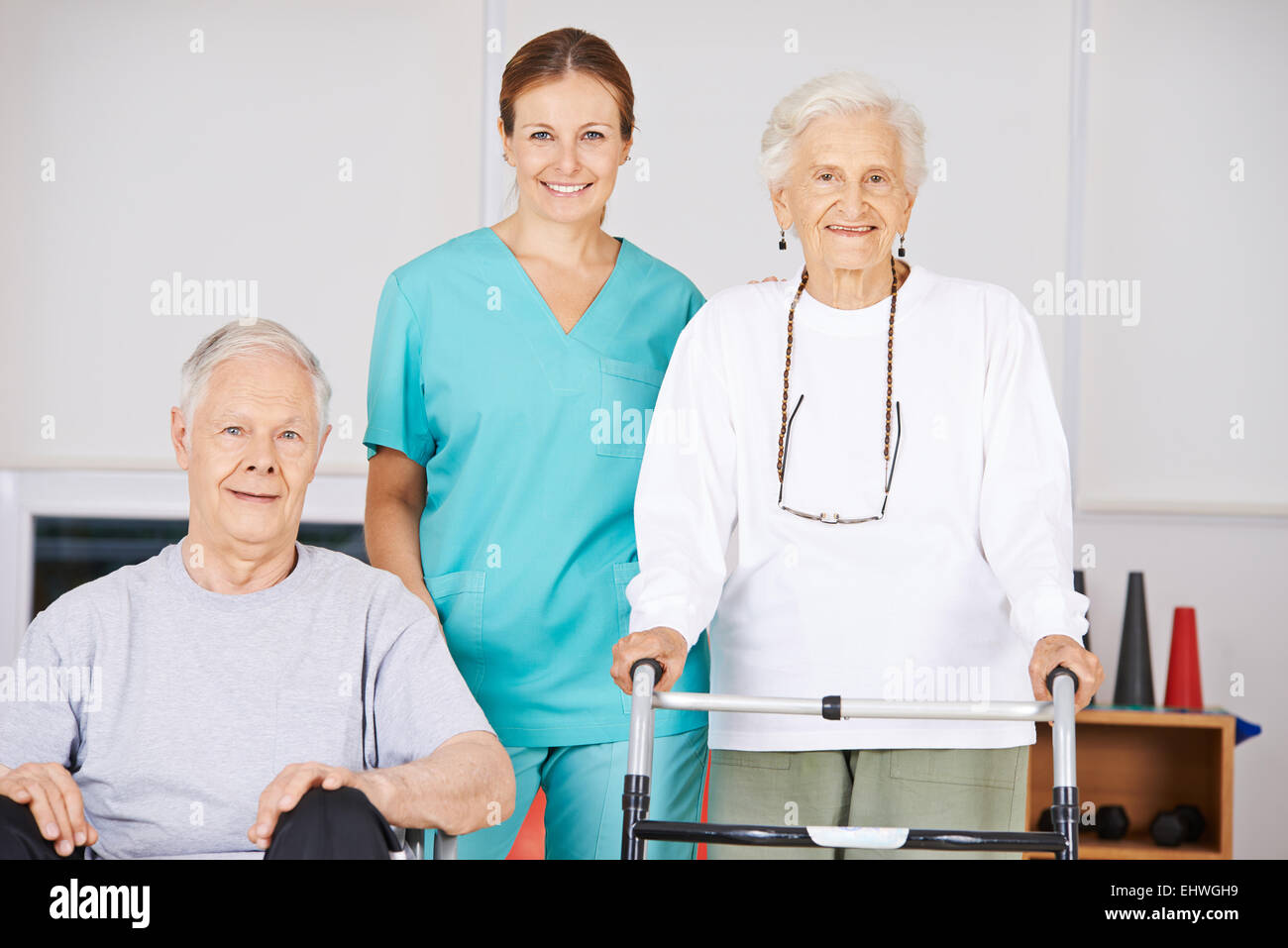 Two old senior people in nursing home with a geriatric nurse Stock ...