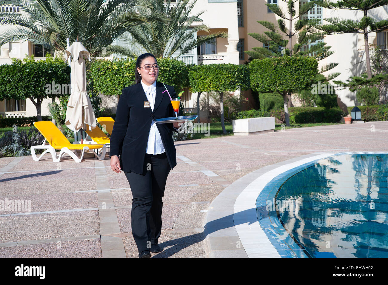 TUNISIA, TUNIS: Waitress serving drinks at pool at Carthage Thalasso ...