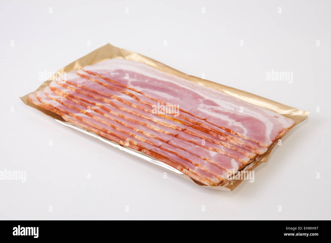 Bacon slices on the package, isolated on white background Stock Photo ...