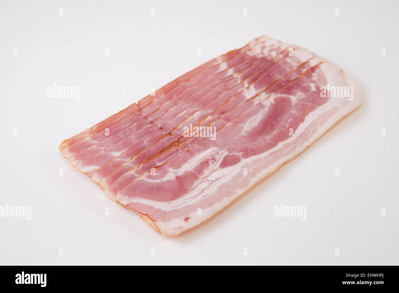 Raw bacon slices isolated on white background Stock Photo - Alamy