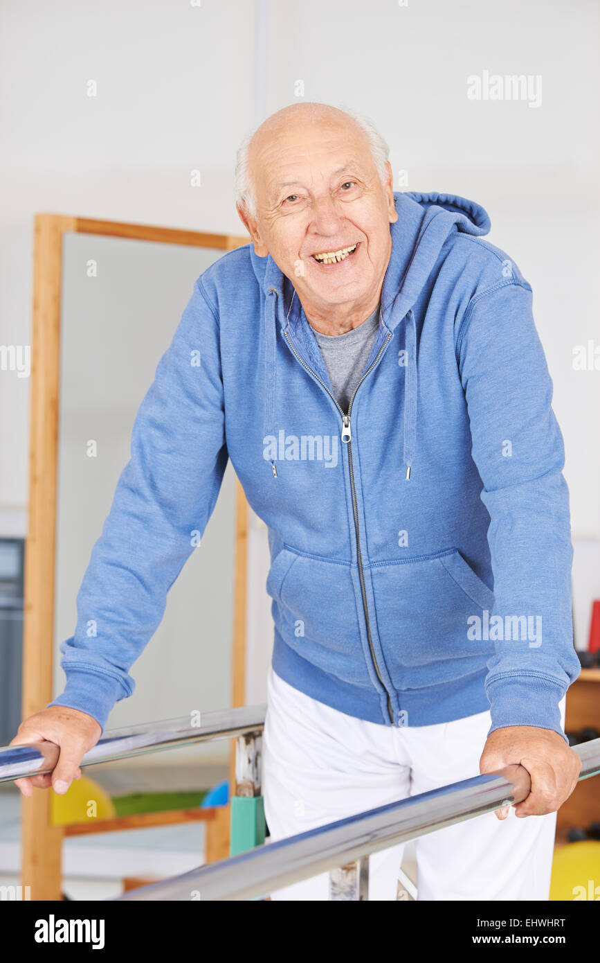 Old man standing on handle in physiotherapy Stock Photo - Alamy
