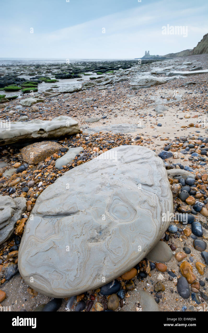 Large stone on the beach at Reculver in Kent Stock Photo - Alamy