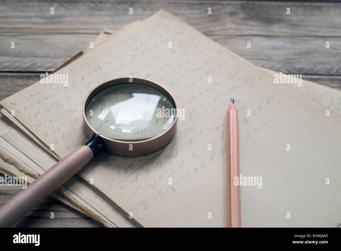 Magnifying glass over papers hi-res stock photography and images - Alamy