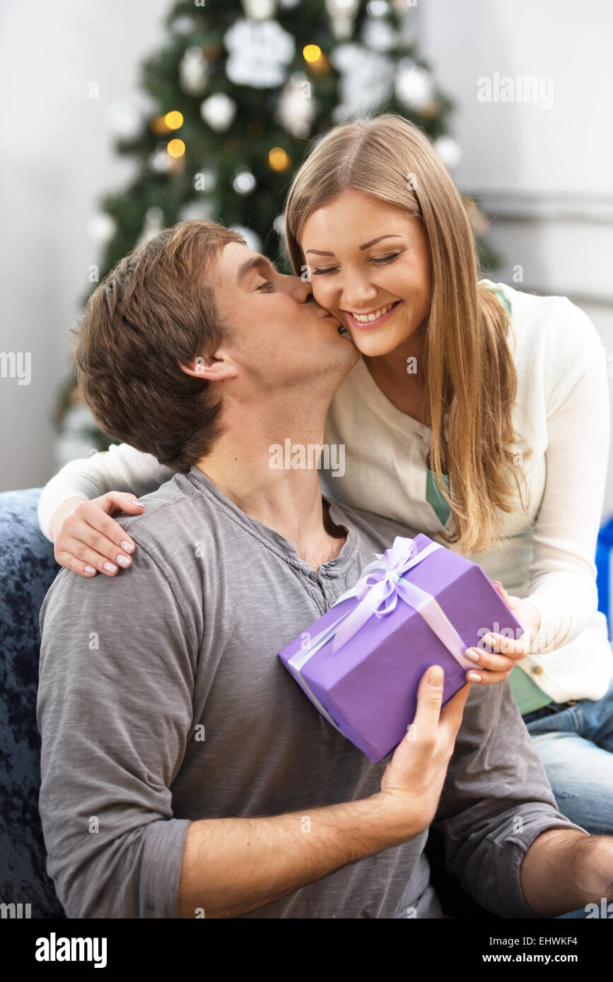 Young man receiving Christmas present Stock Photo - Alamy