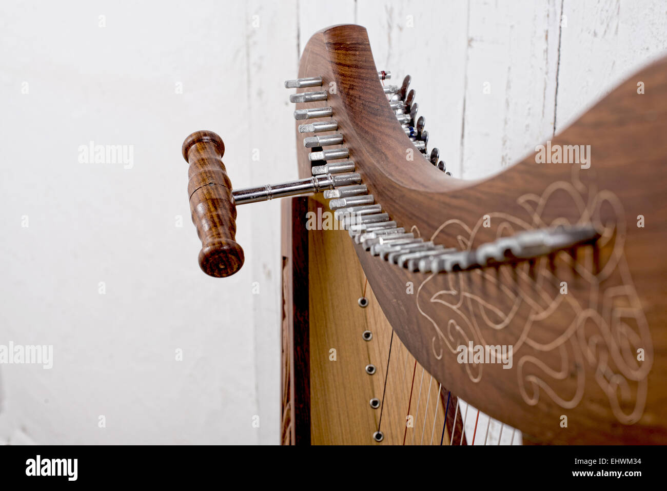 closeup on the setting up of a harp with tool Stock Photo - Alamy