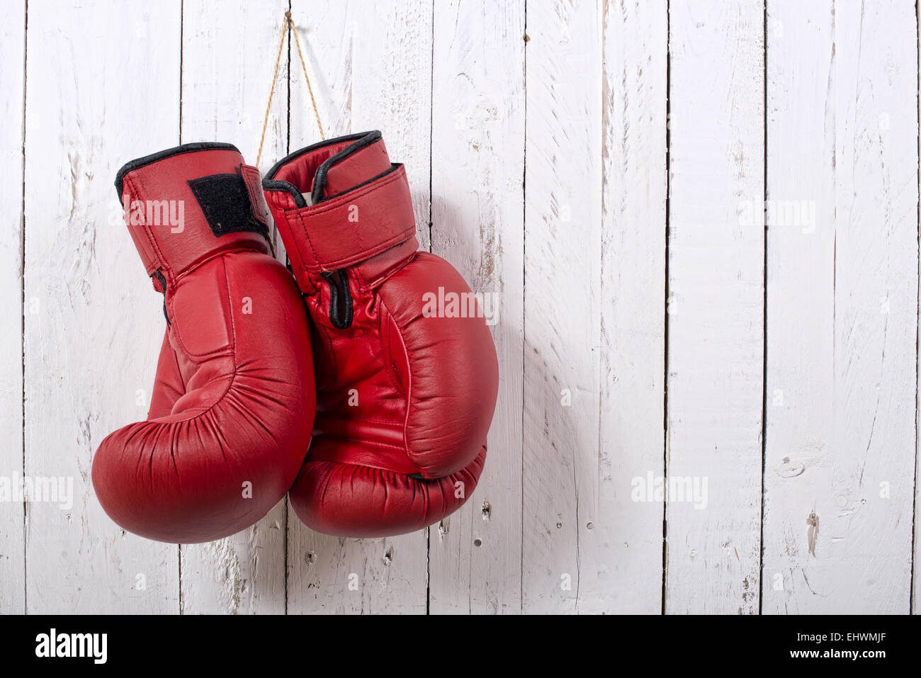 red boxing gloves hanging on the wall Stock Photo - Alamy