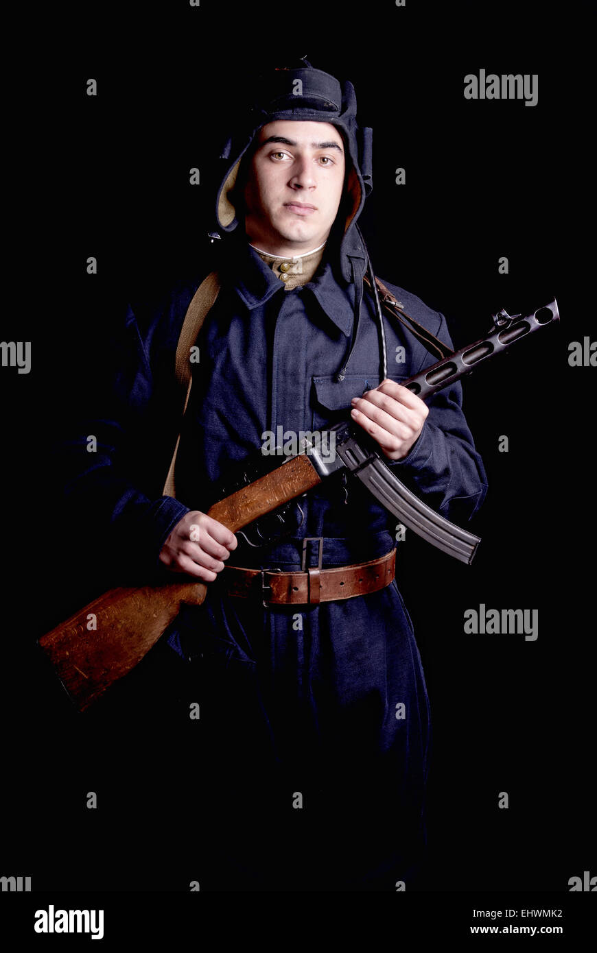 young Soviet tank driver with his gun on black background Stock Photo ...