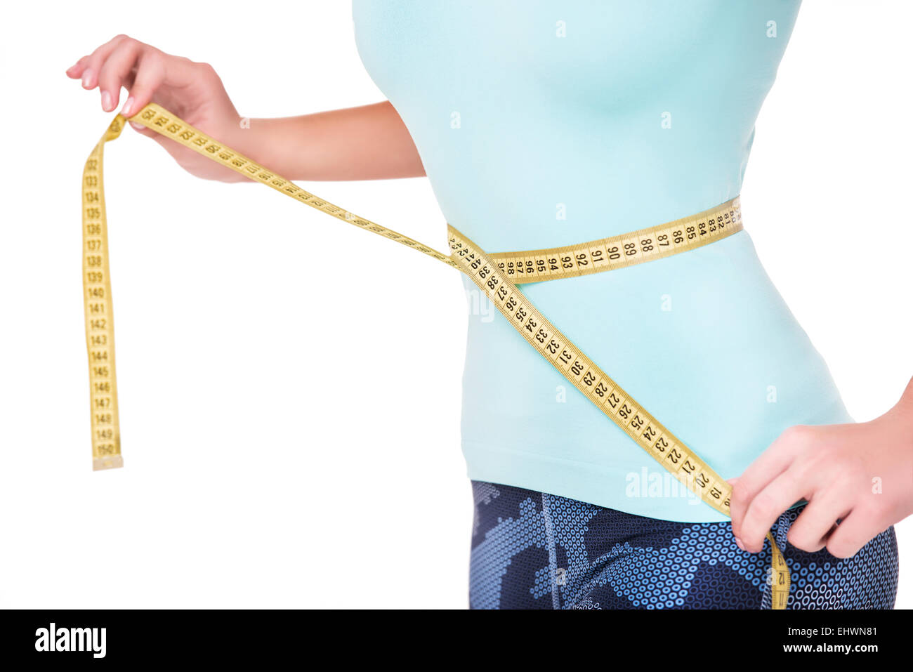 Close up of fit woman measuring her waist Stock Photo - Alamy