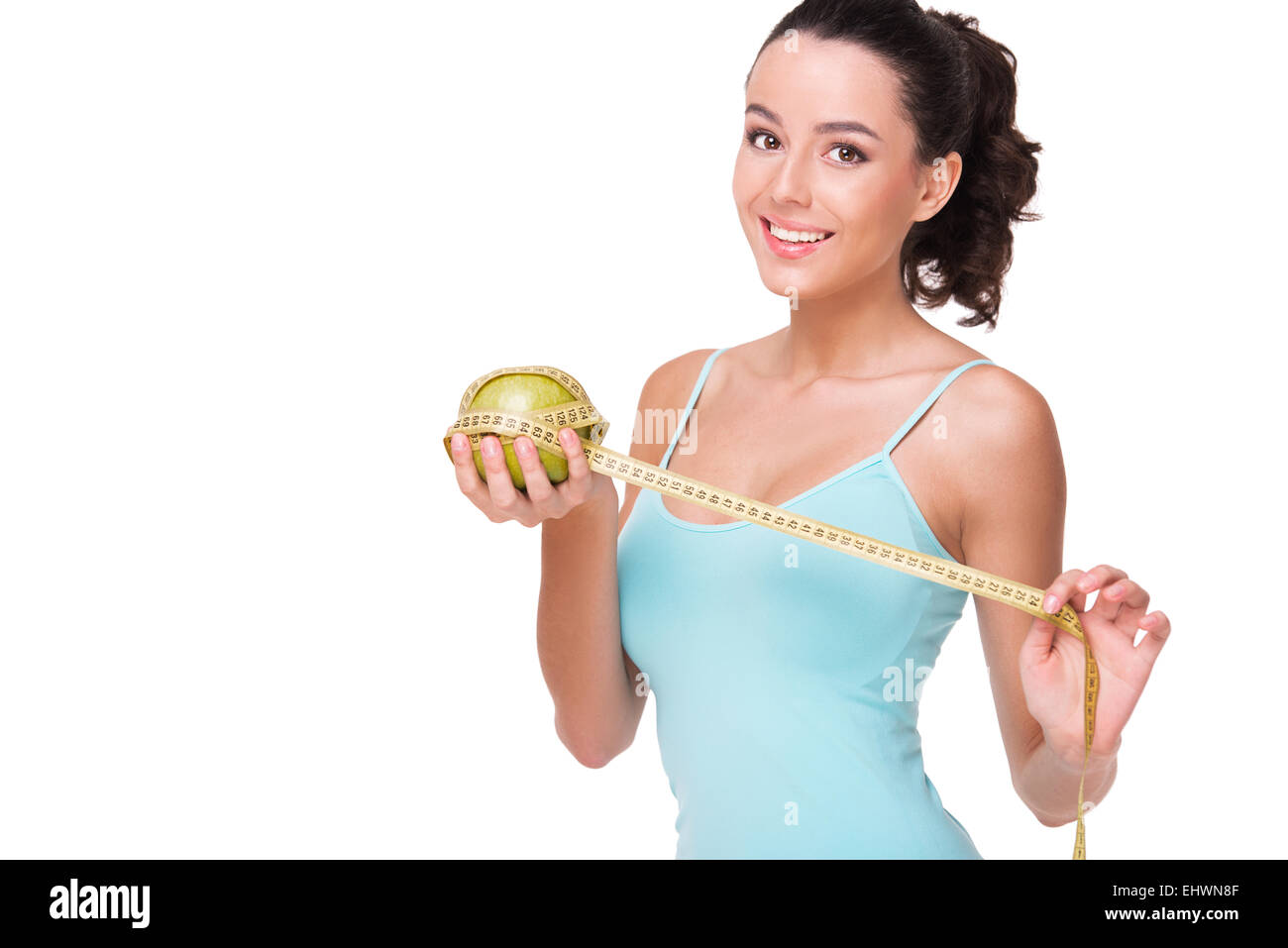 Fit woman measuring apple with tape Stock Photo - Alamy