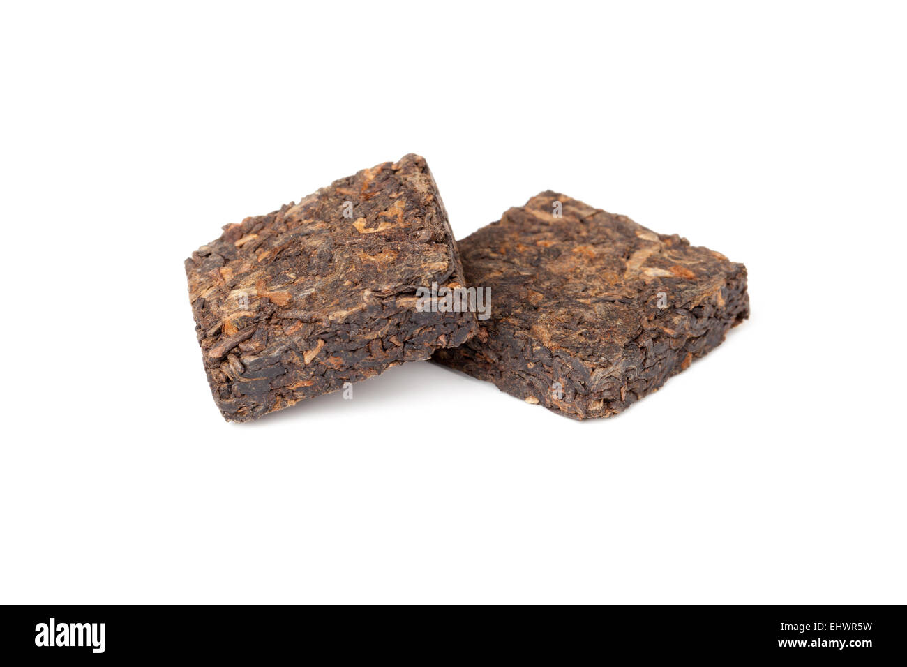 Two small pressing briquette of black Chinese Shu Pu Erh tea isolated ...