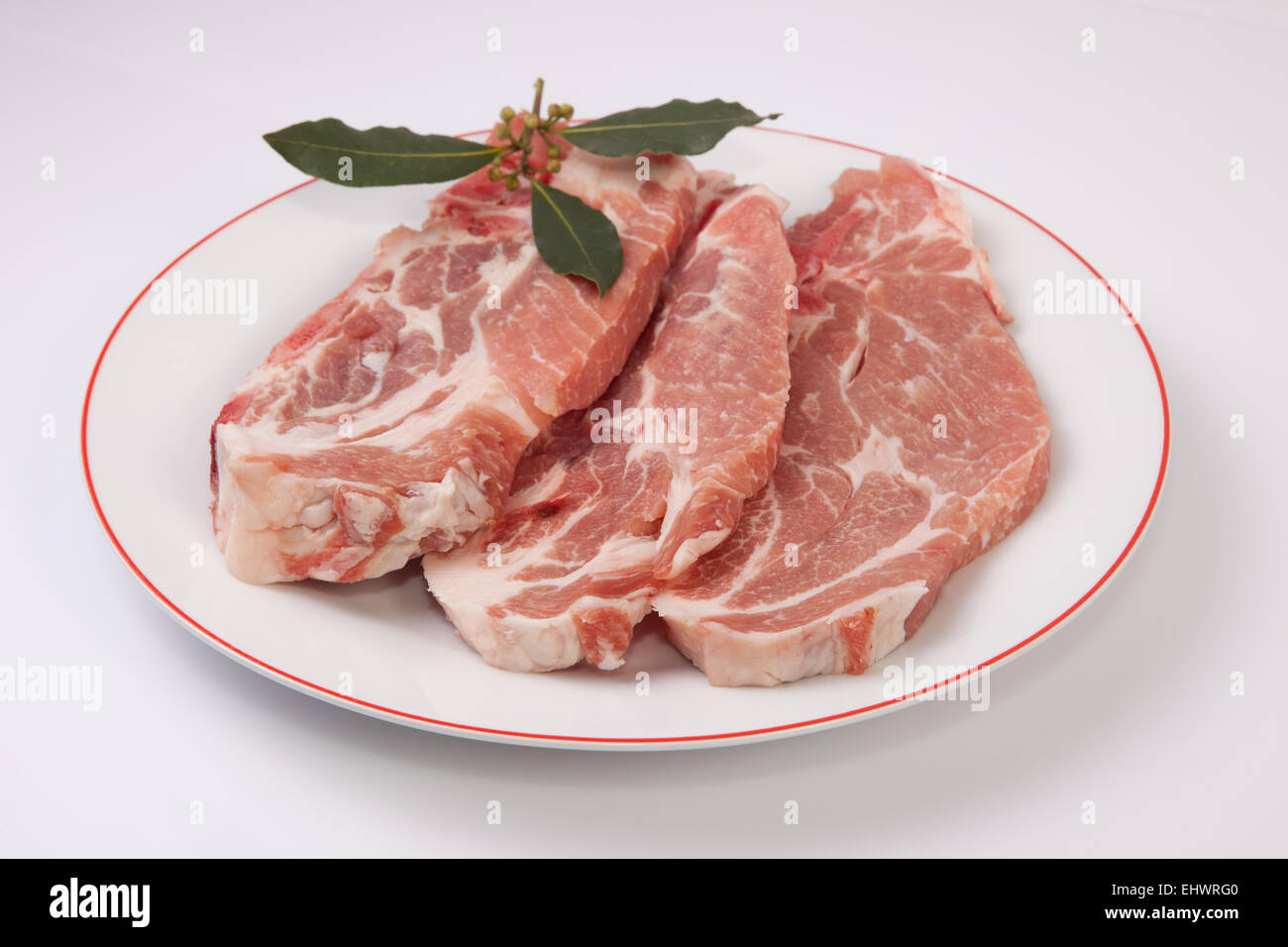 Middle rib chops of pork over plate. Isolated on white with bay Stock ...