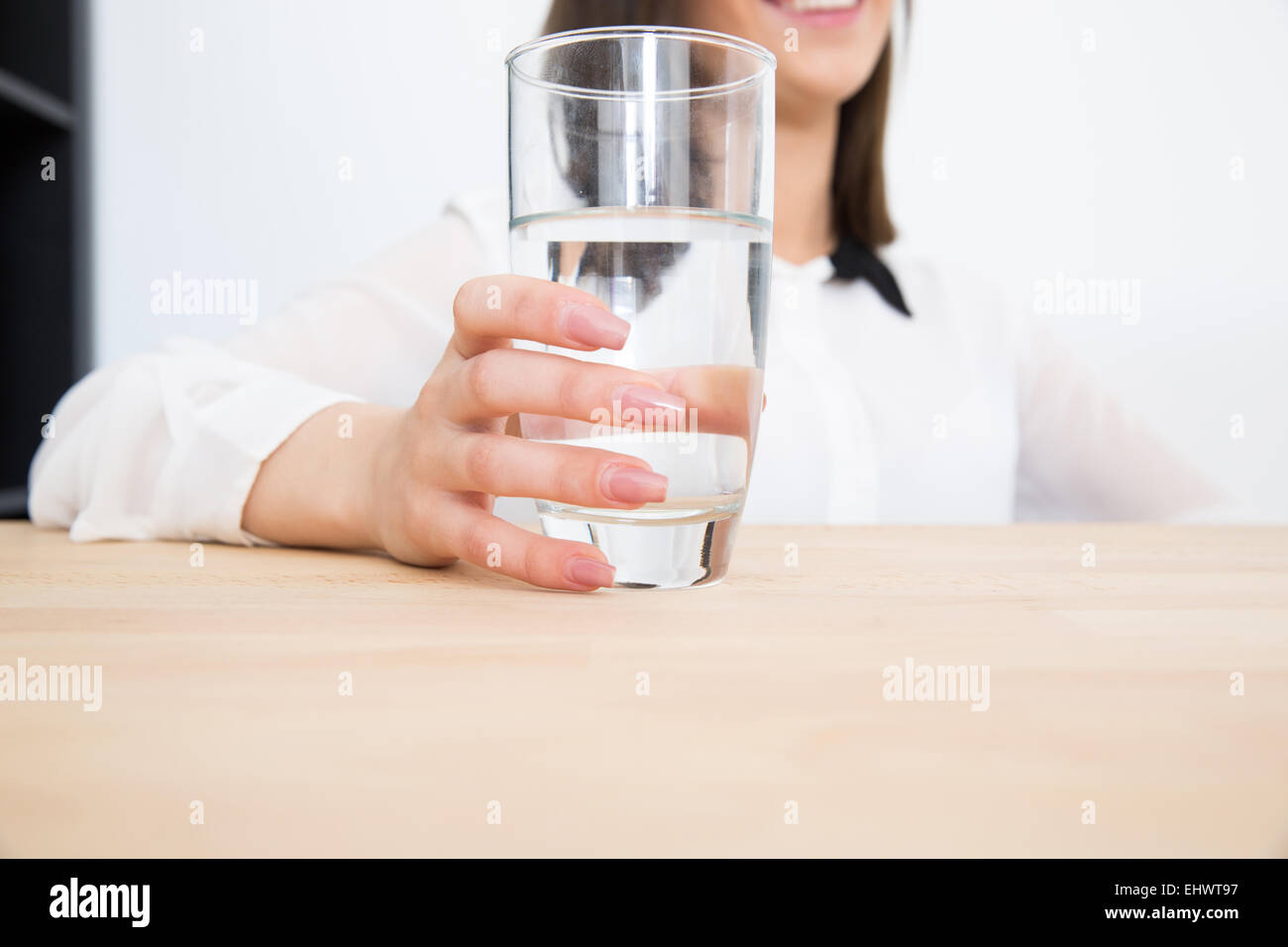 Closeup image of female hand holding glass Stock Photo - Alamy
