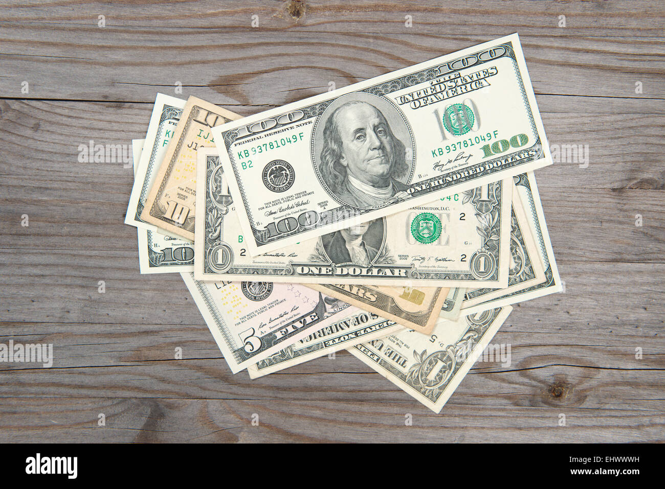 Pile of bank notes on old wooden desk Stock Photo - Alamy