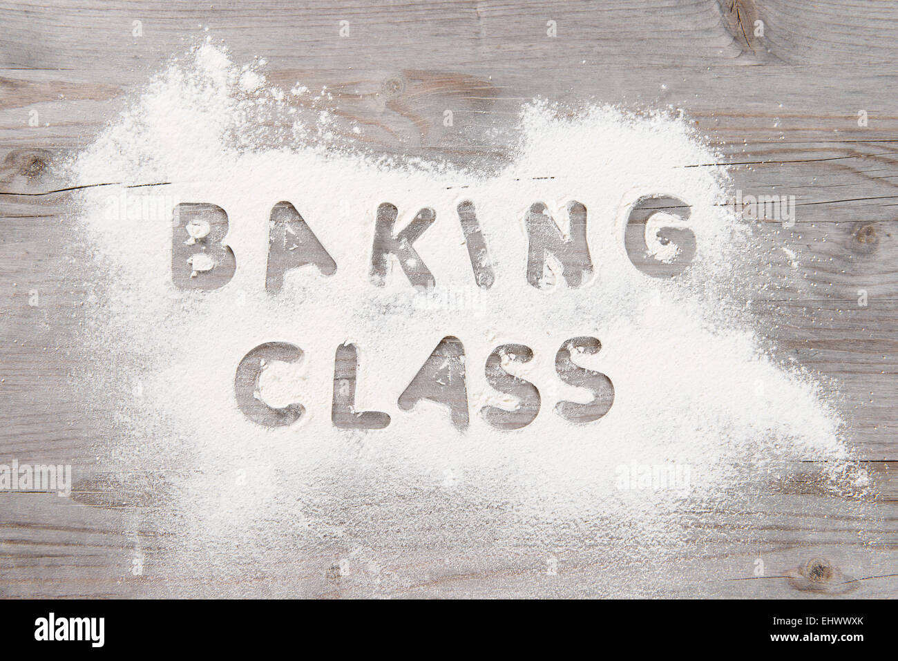 Baking classes poster design with flour on wooden table from overhead ...