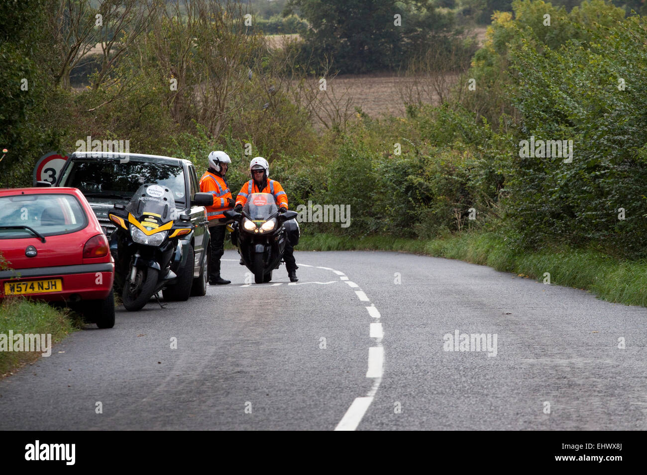 Two motorcycle marshals at the 2011 Tour of Britain Stock Photo - Alamy