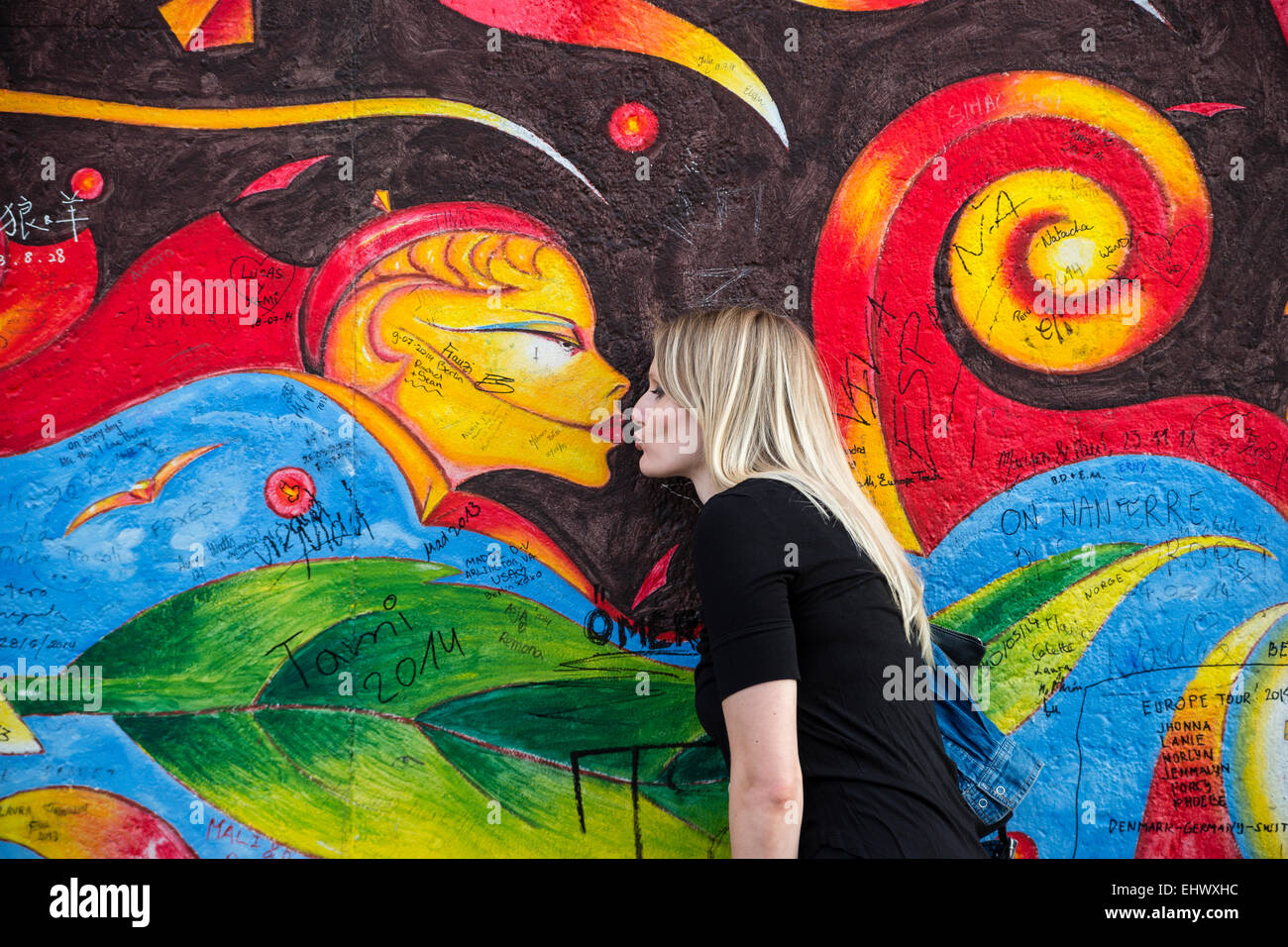 Germany, Berlin, woman standing in front of mural on Berlin Wall Stock ...