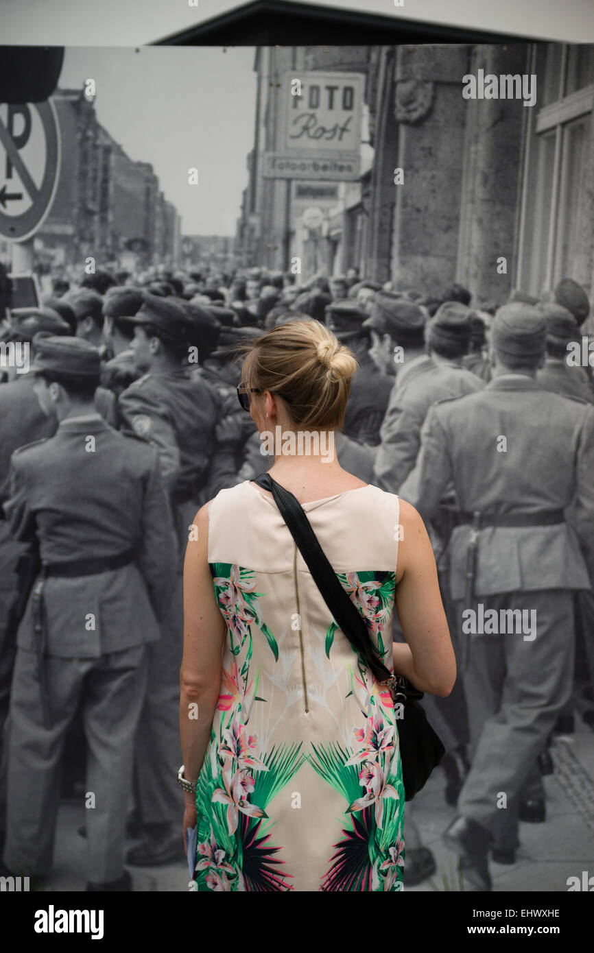 Germany, Berlin, woman standing in front of memorial plaques at ...