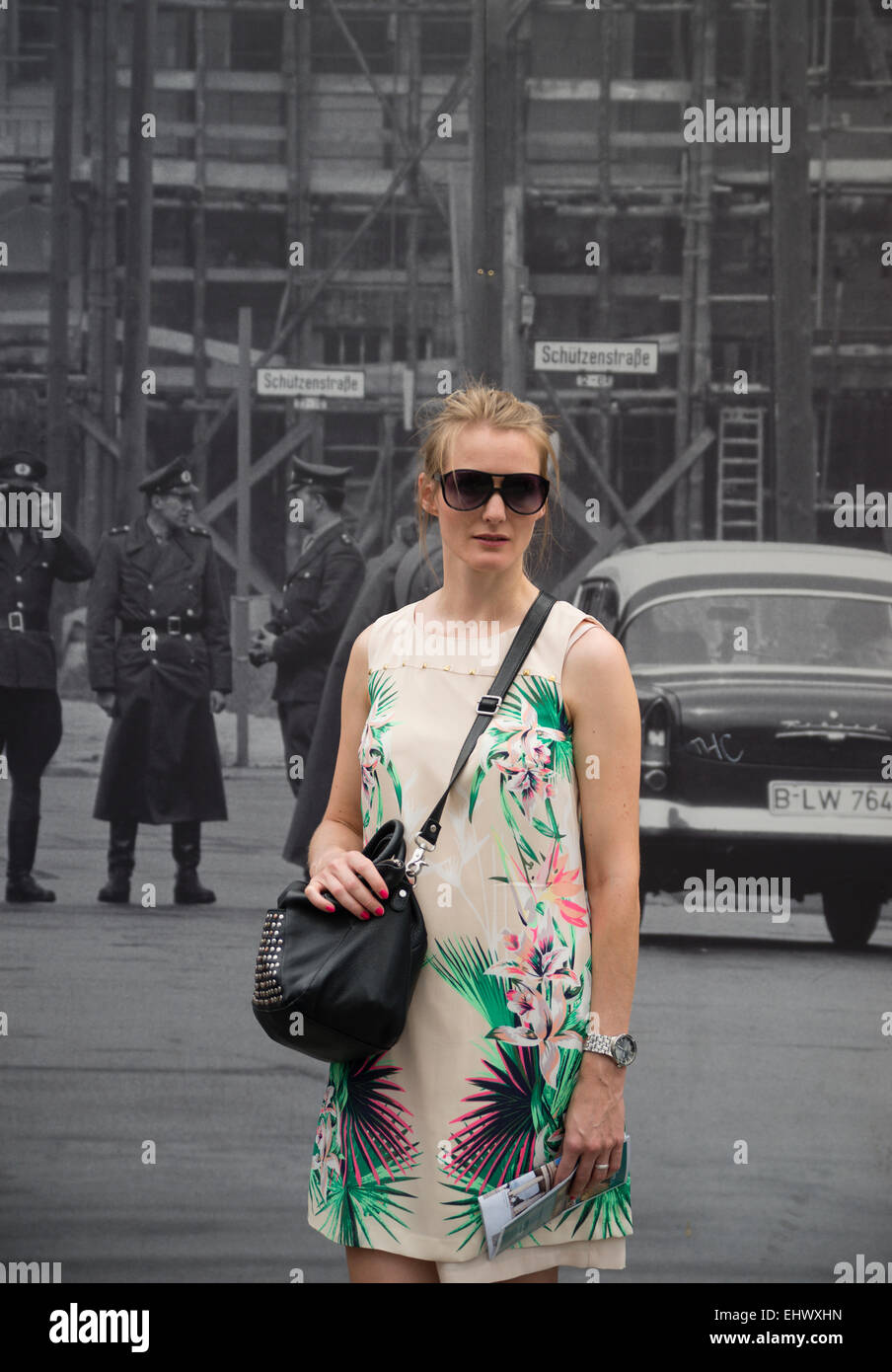 Germany, Berlin, woman standing in front of memorial plaques at ...