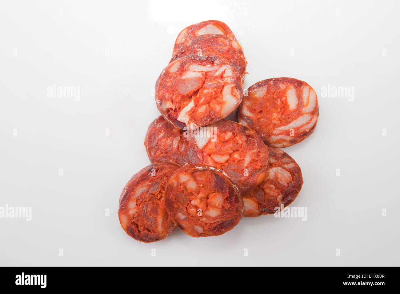Some cut pieces of red iberian chorizo. Isolated over white background ...