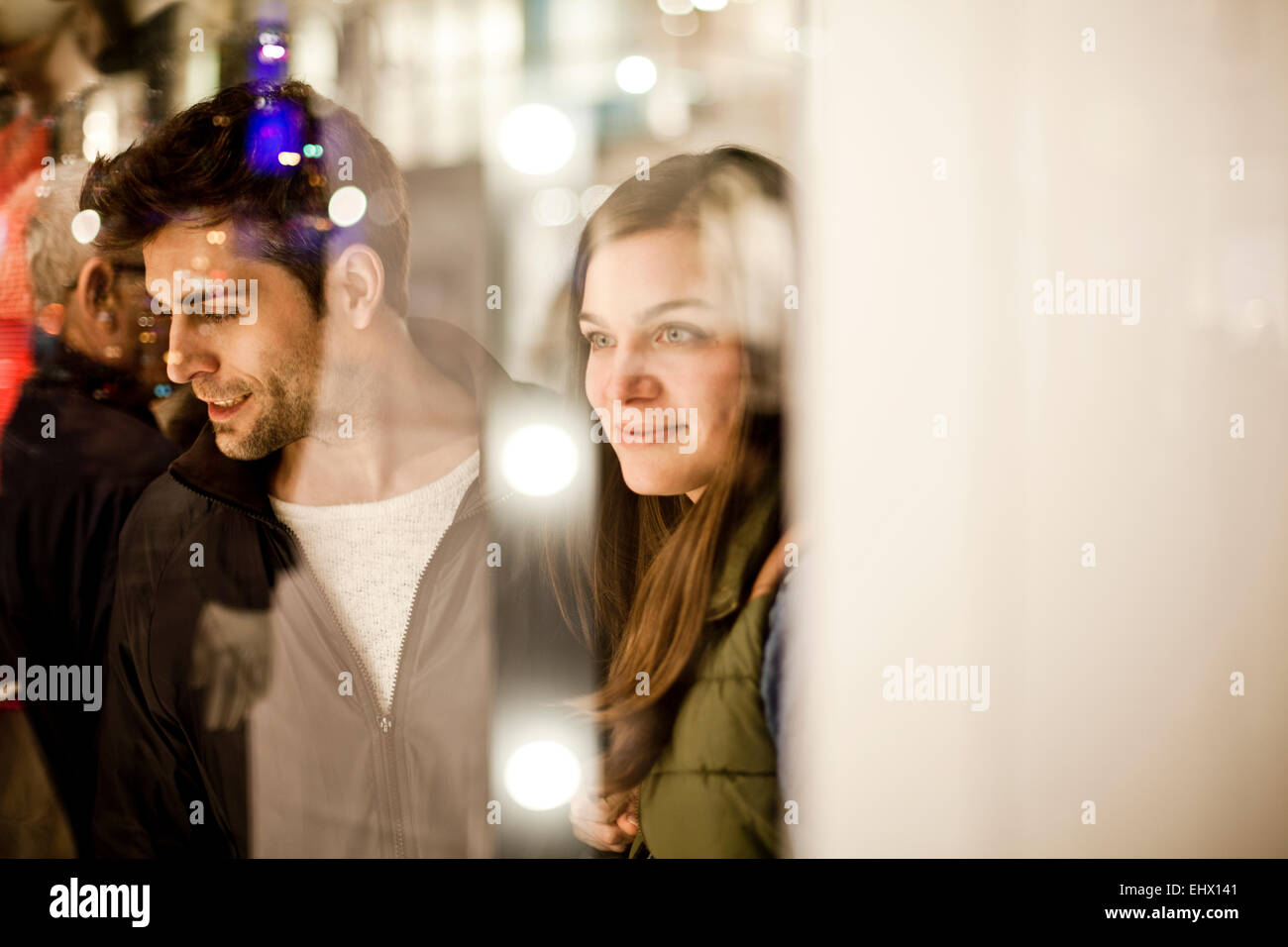Germany, Cologne, young couple looking at window display Stock Photo ...