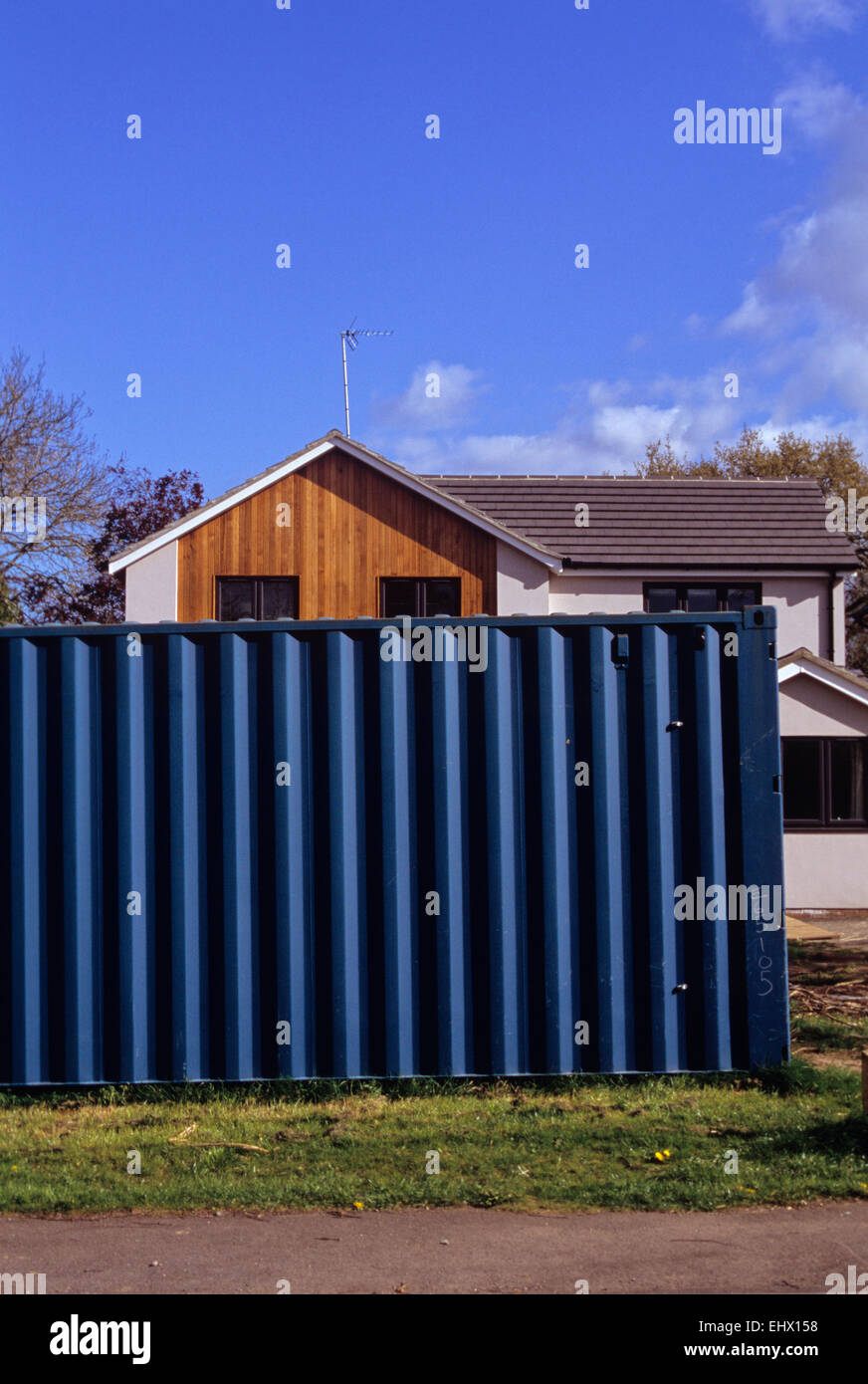 shipping container used a garden shed in front garden of house in ...