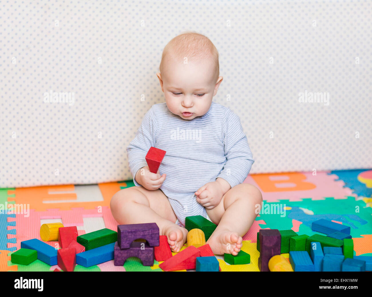 Cute little baby playing with colorful toys at home Stock Photo - Alamy