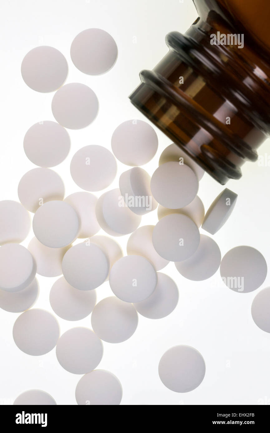 Drugs used in the treatment of illness pouring from a medicine bottle ...