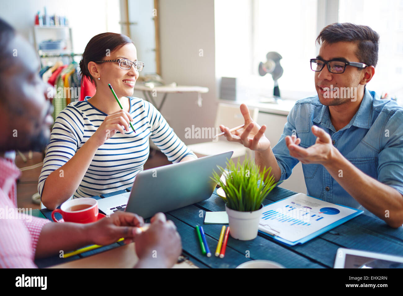 Group of people communicating in studio Stock Photo - Alamy