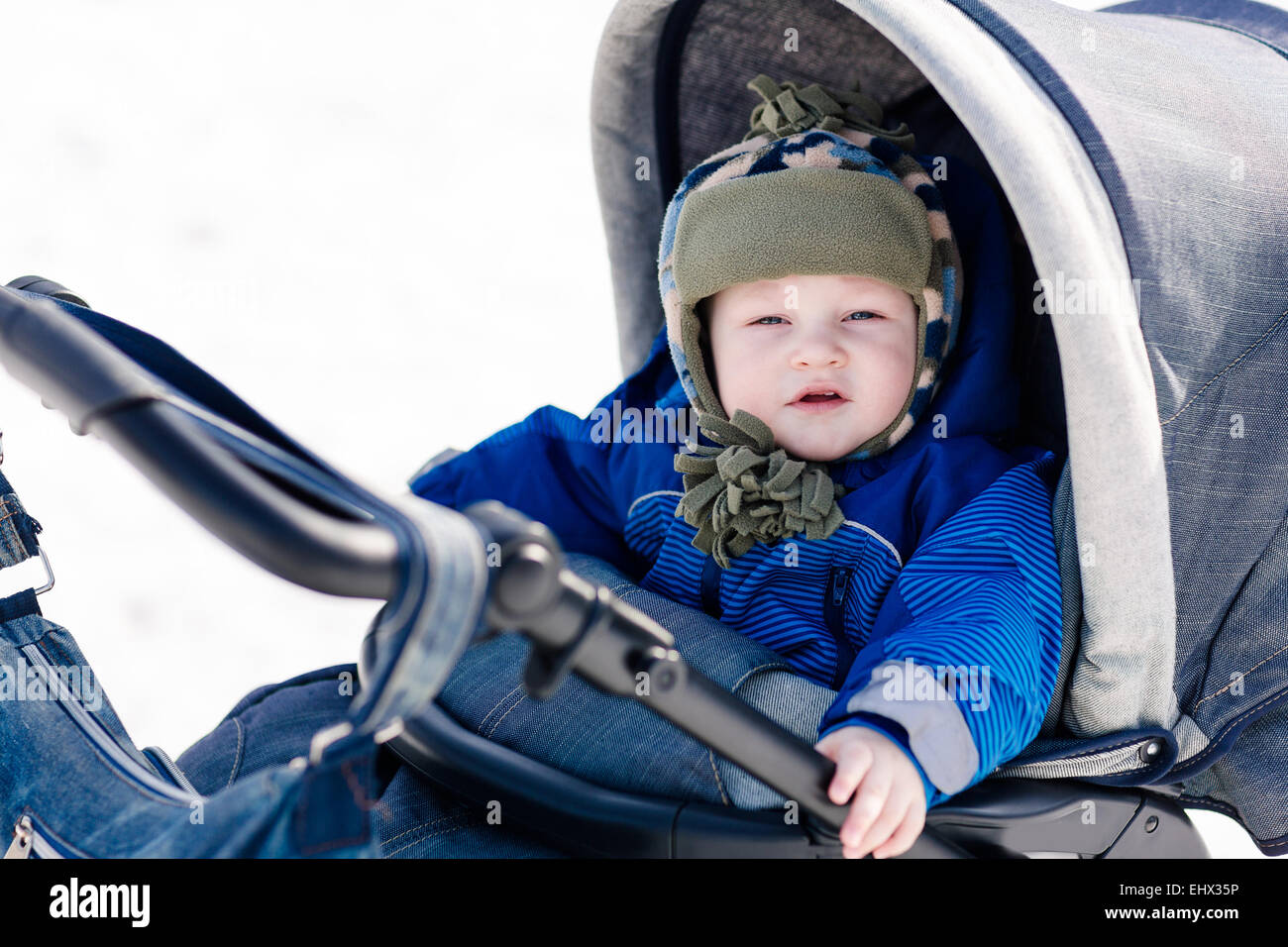 Cute little baby in a stroller outdoor in winter Stock Photo - Alamy