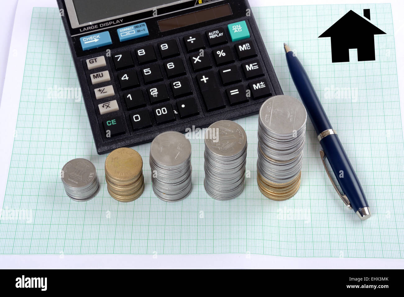 Pen and calculator with coins Stock Photo - Alamy