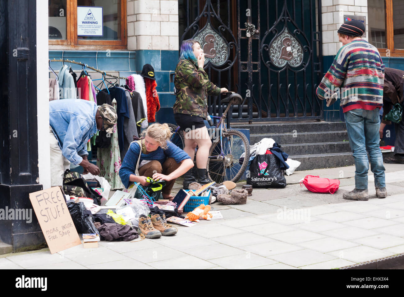 Free stuff more inside free shop - people looking at items on street ...