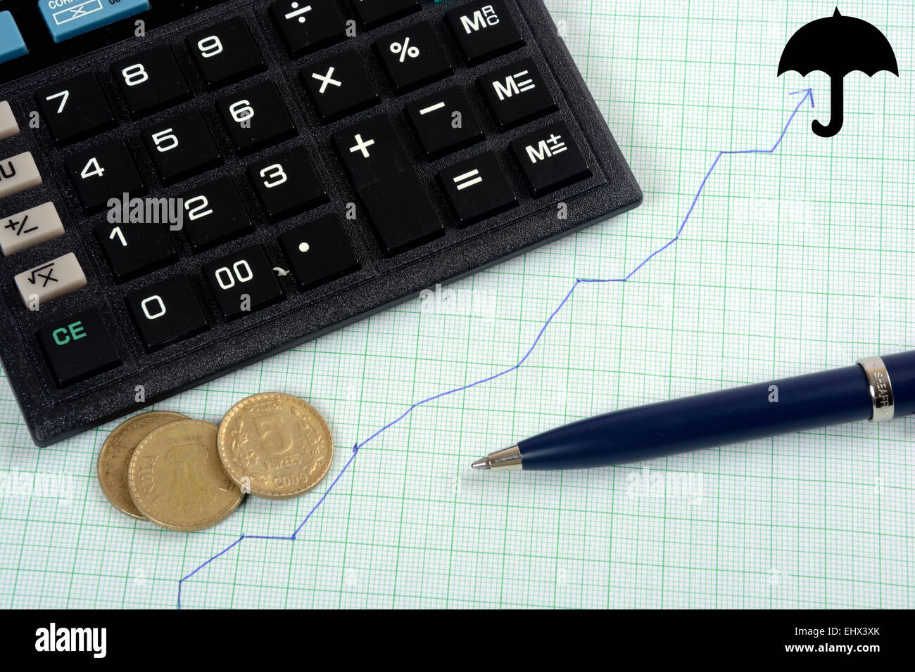 Pen and calculator with coins Stock Photo - Alamy
