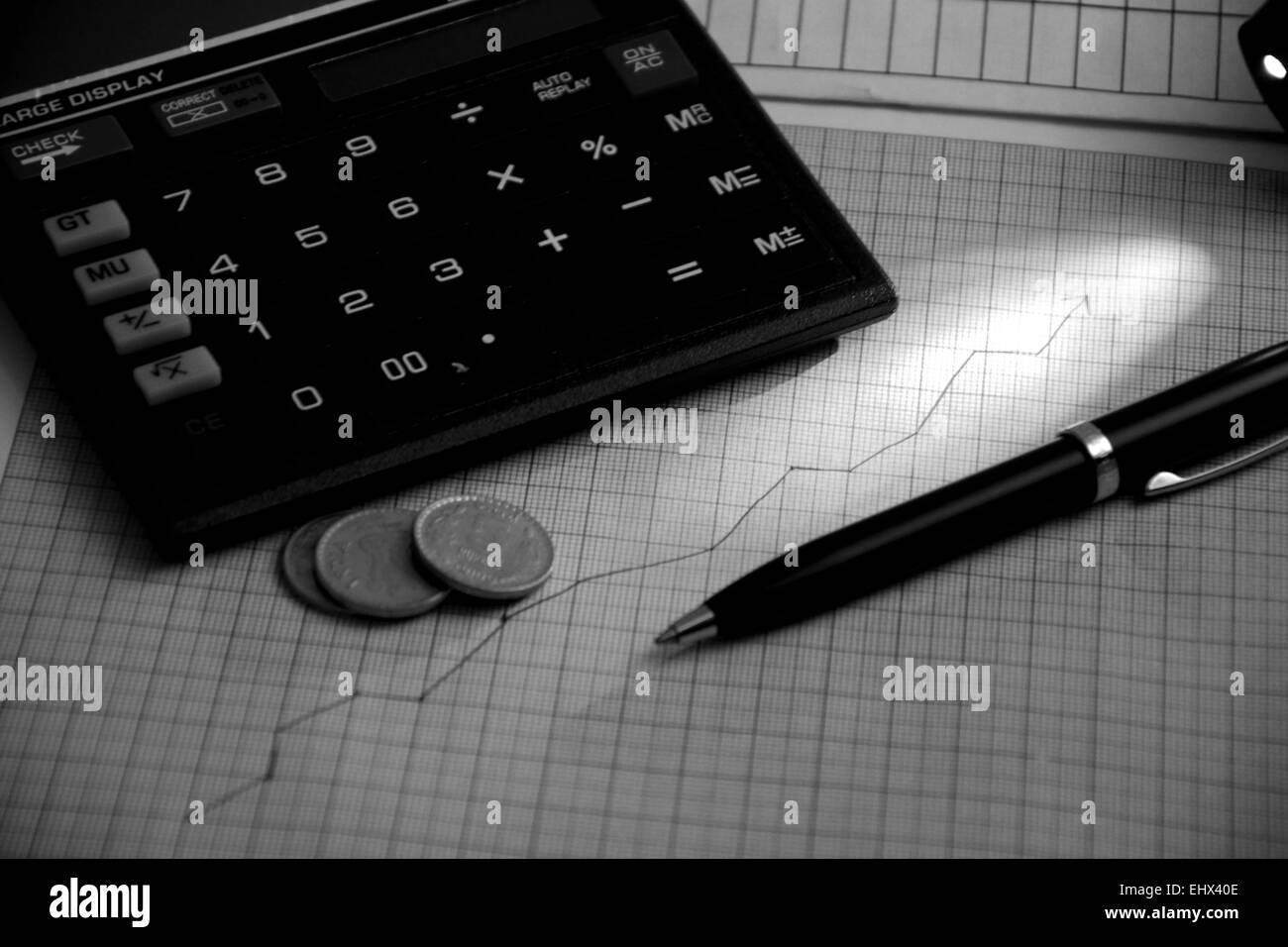 Pen and calculator with coins Stock Photo - Alamy