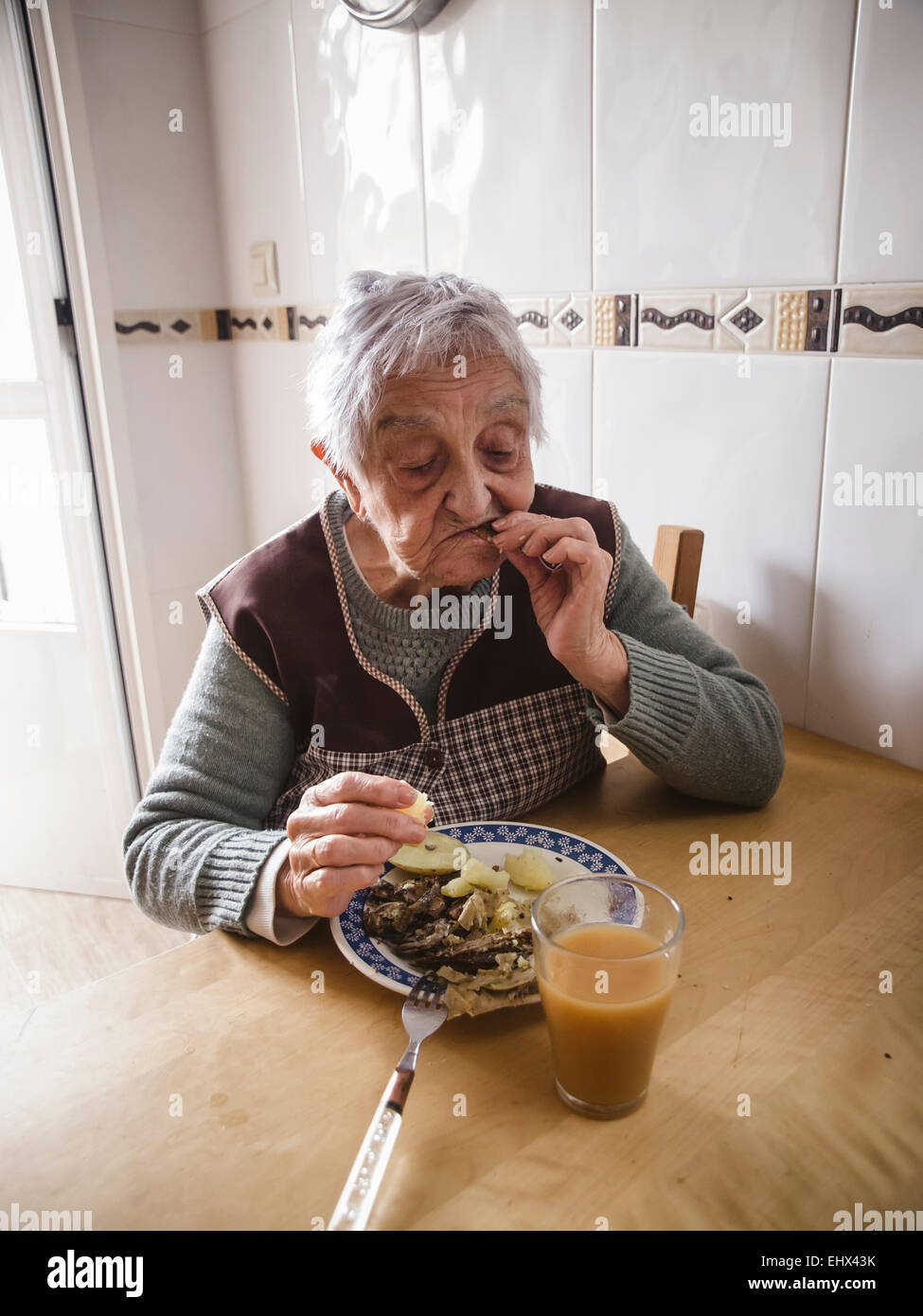 Senior woman eating fish hi-res stock photography and images - Alamy