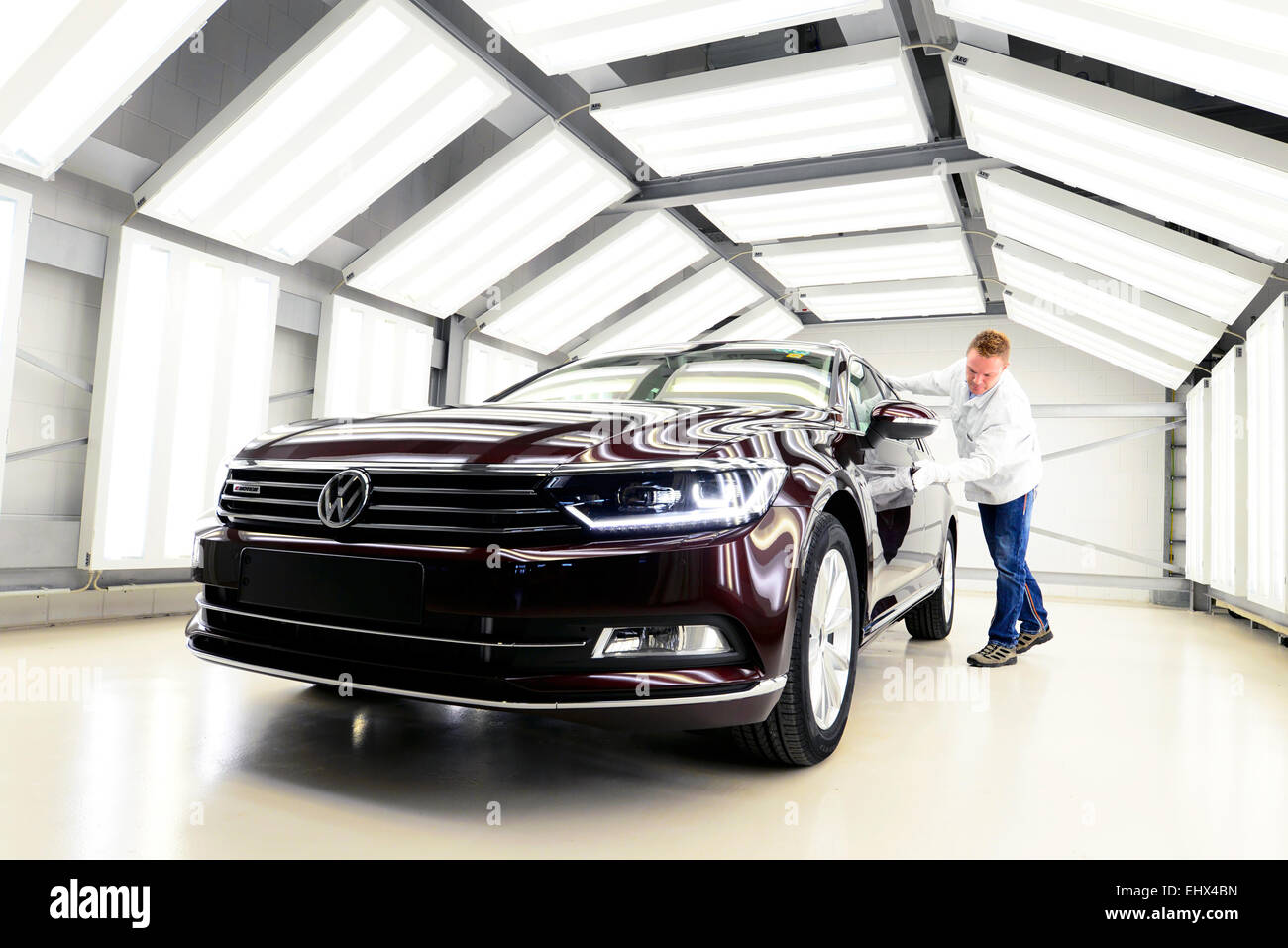 Production of VW cars in a factory, car in light tunnel for final check ...