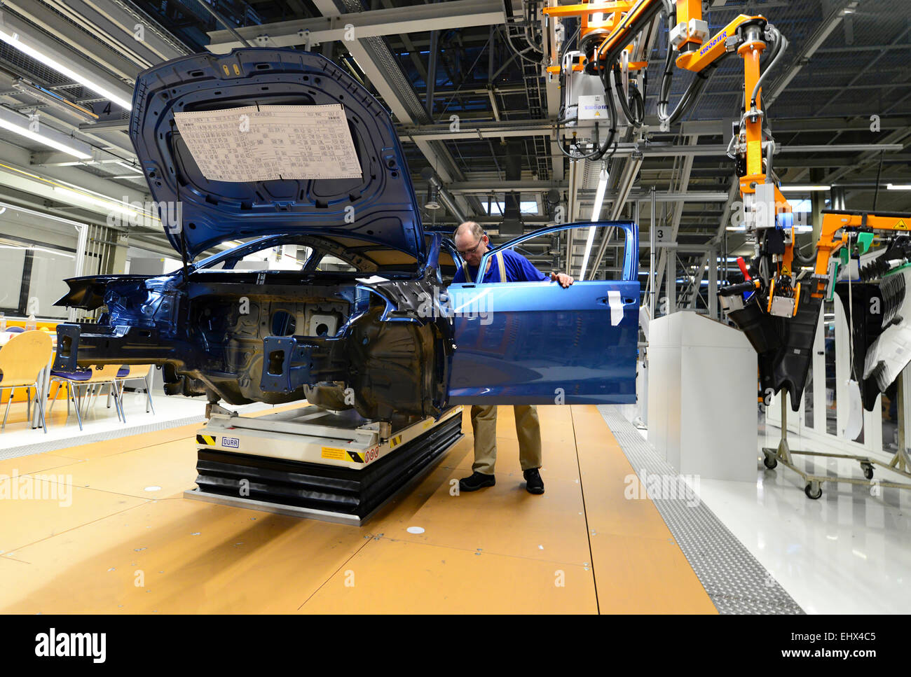 Production of VW cars in a factory, worker installing car door Stock ...