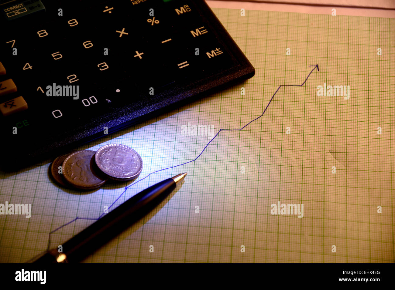 Pen and calculator with coins Stock Photo - Alamy