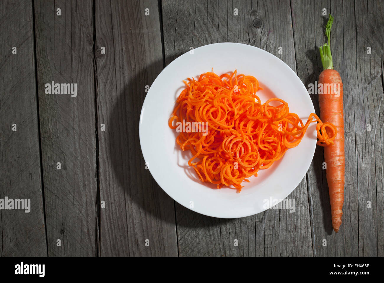 Carrot spirals on plate and wood Stock Photo - Alamy