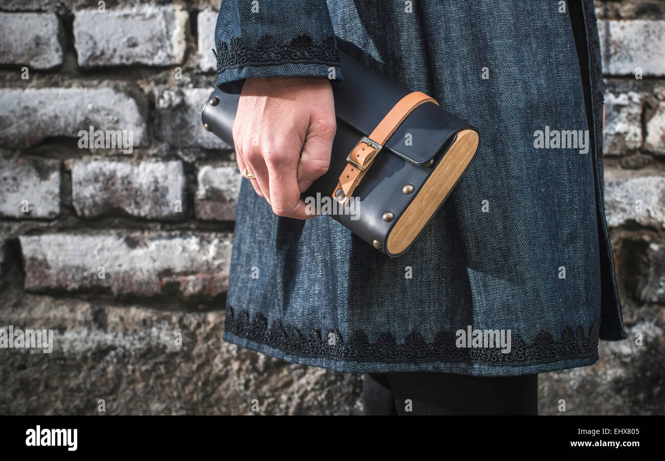 Woman's hand holding leather handbag Stock Photo - Alamy