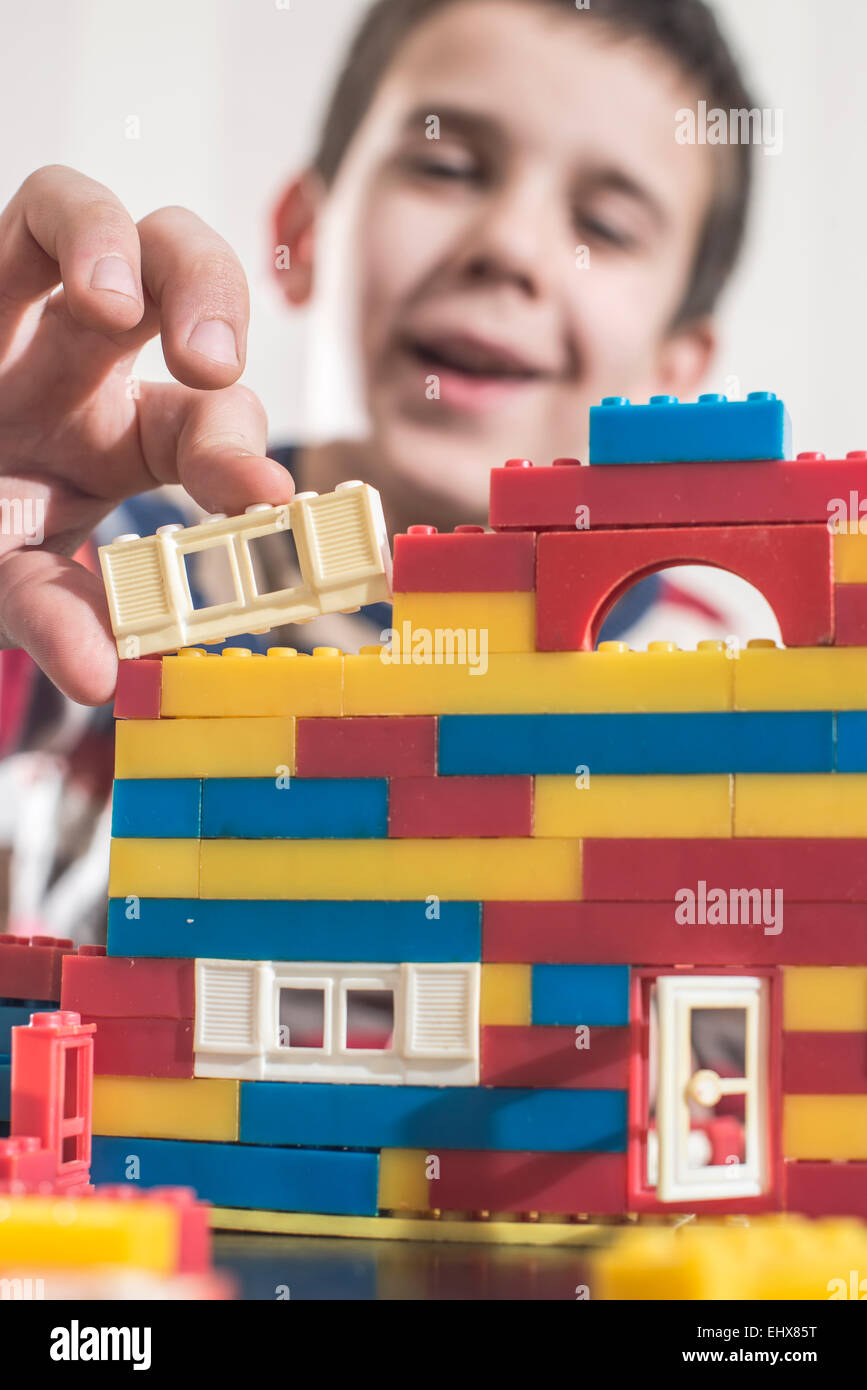 Boy playing with children's building bricks Stock Photo - Alamy